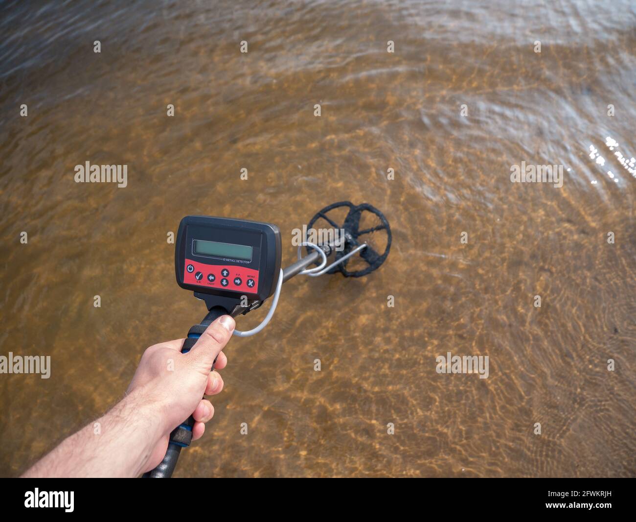 Close-up of a metal detector submerged in water Stock Photo - Alamy