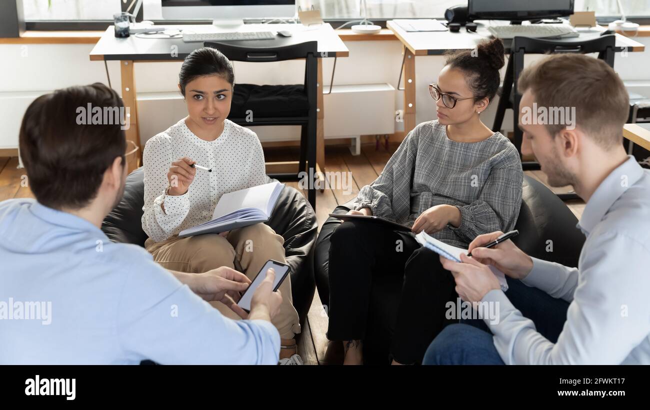 Diverse colleagues employees brainstorming, involved in briefing ...