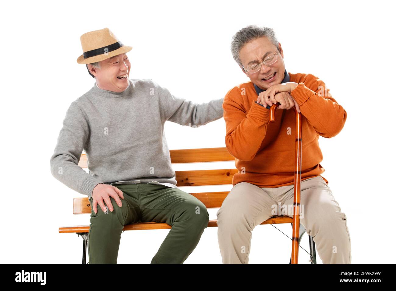 The two old friends sat on the bench to chat Stock Photo - Alamy