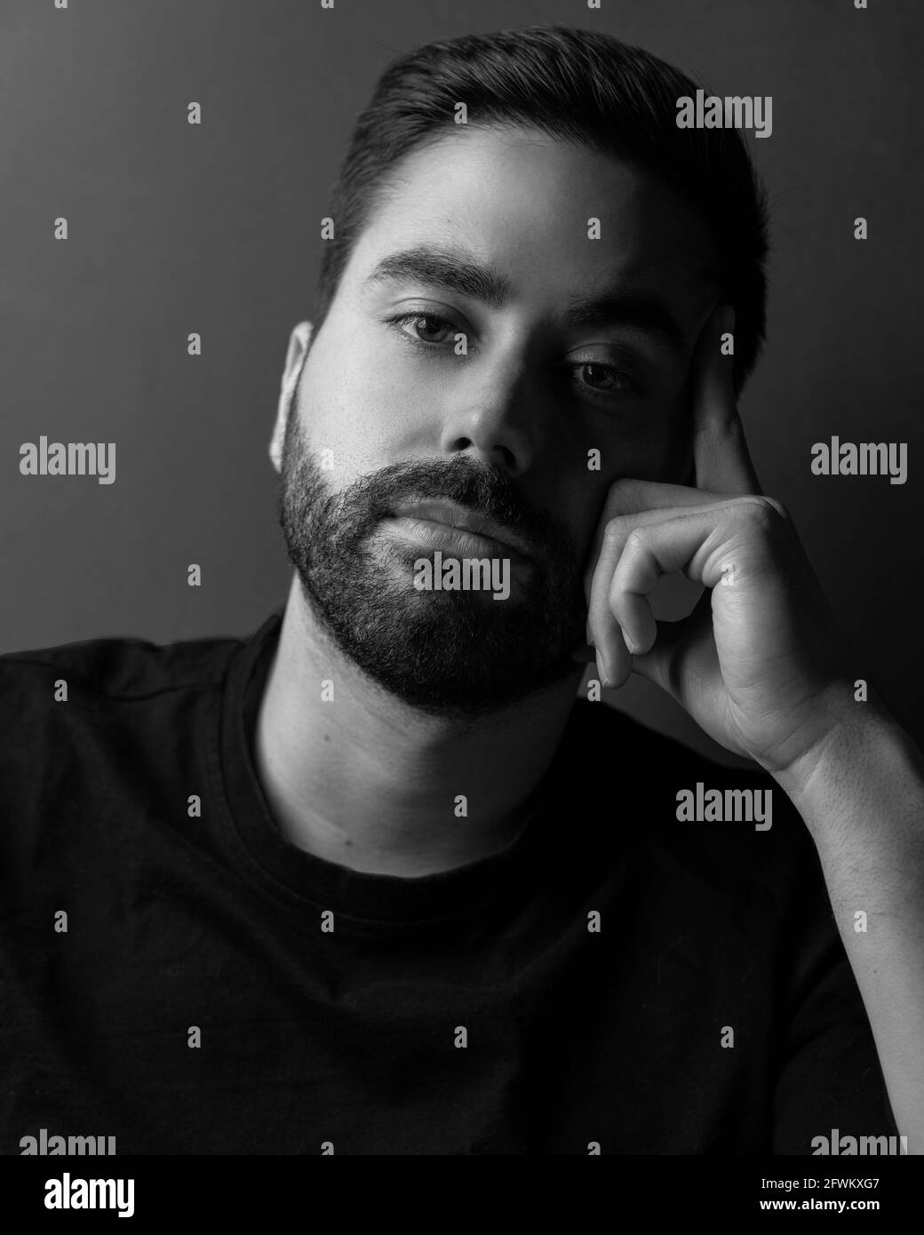 A grayscale portrait of a young Caucasian male with a beard Stock Photo ...