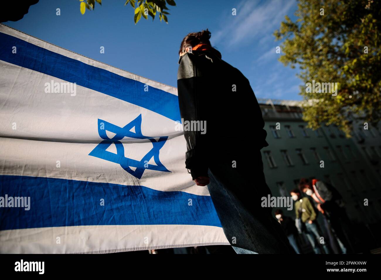 Berlin, Germany. 23rd May, 2021. With an Israeli flag, participants of ...