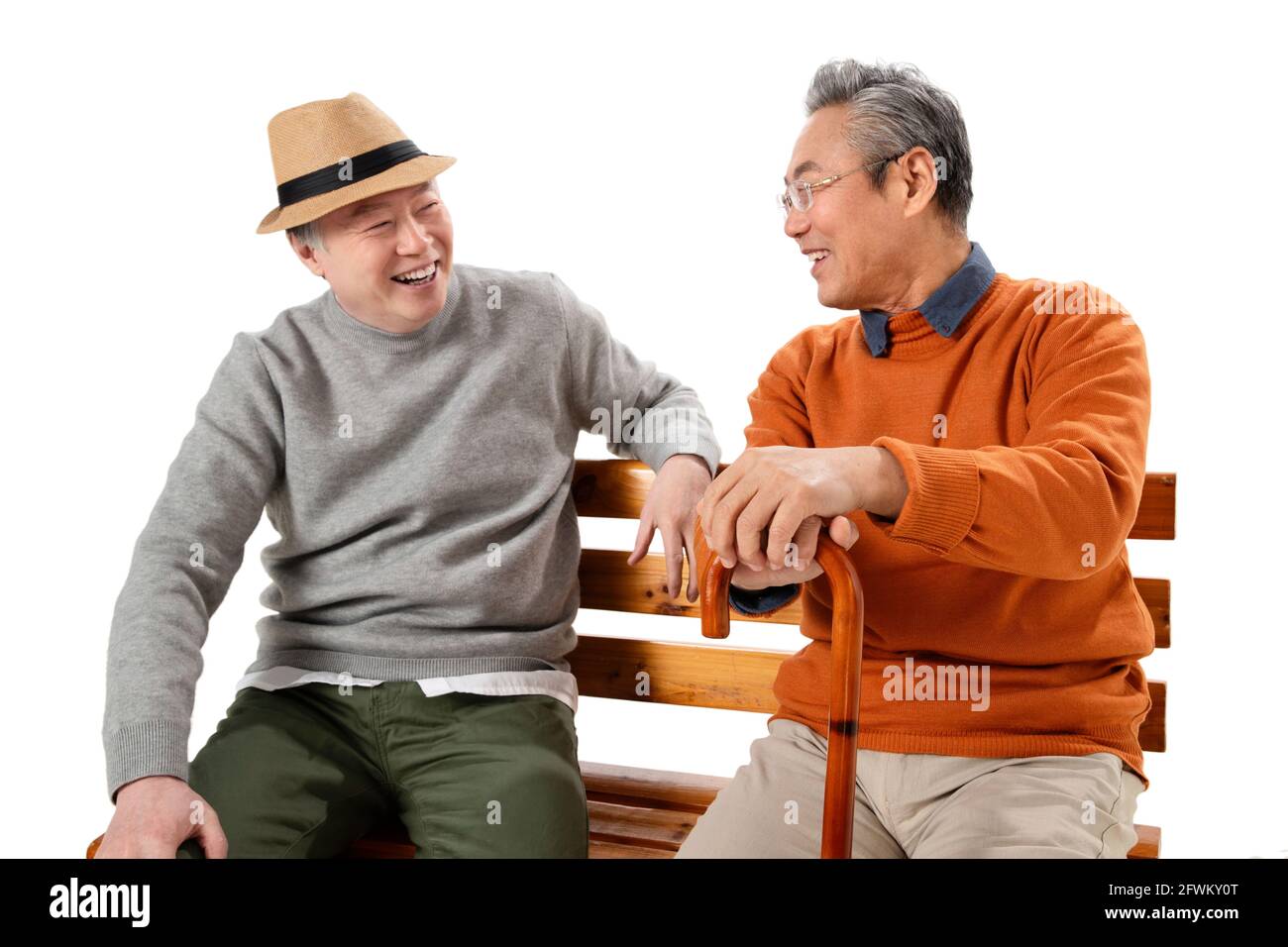 The two old friends sat on the bench to chat Stock Photo - Alamy