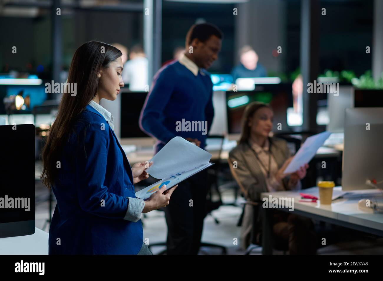 Young managers works in night office Stock Photo - Alamy