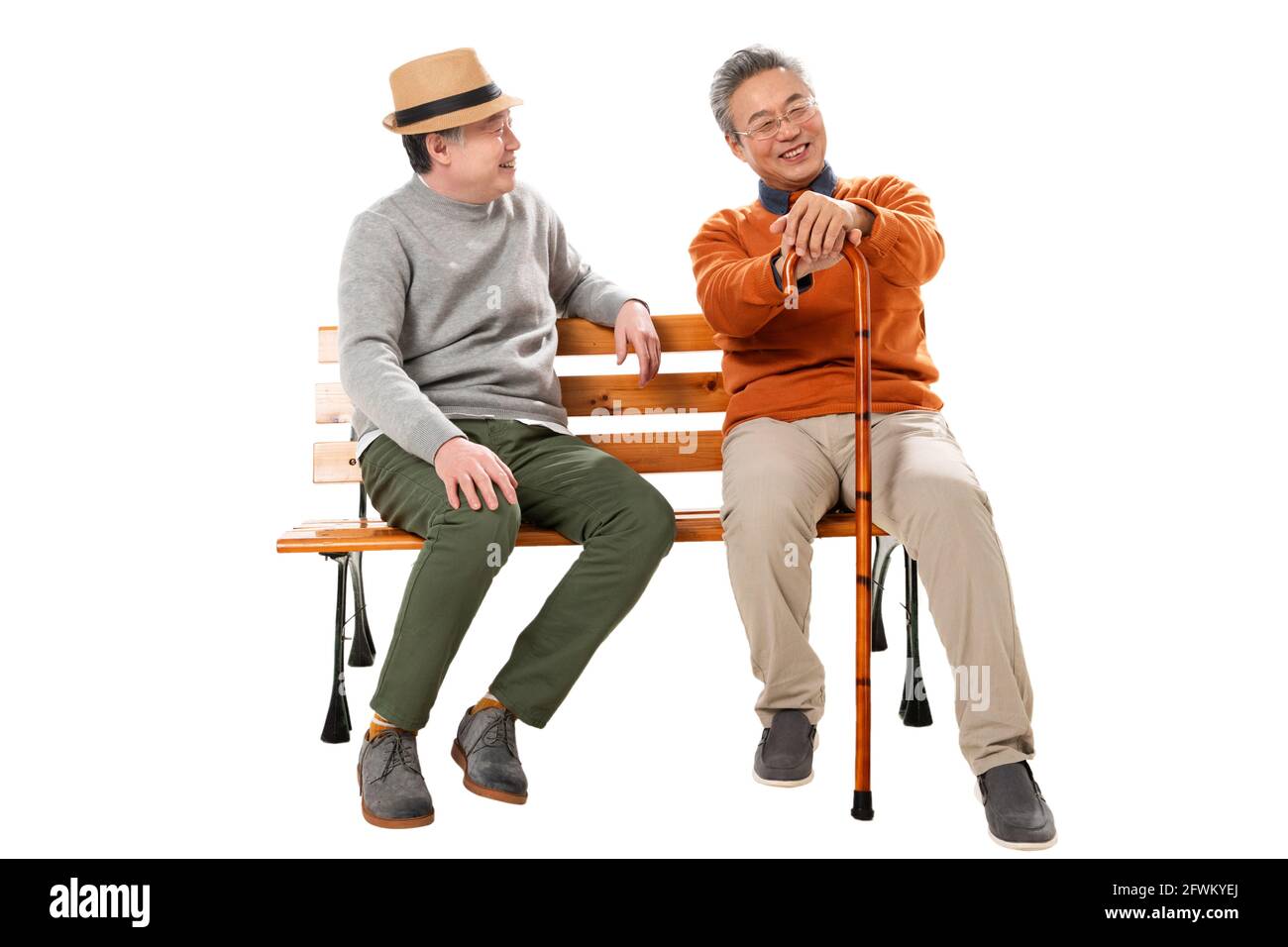 The two old friends sat on the bench to chat Stock Photo - Alamy