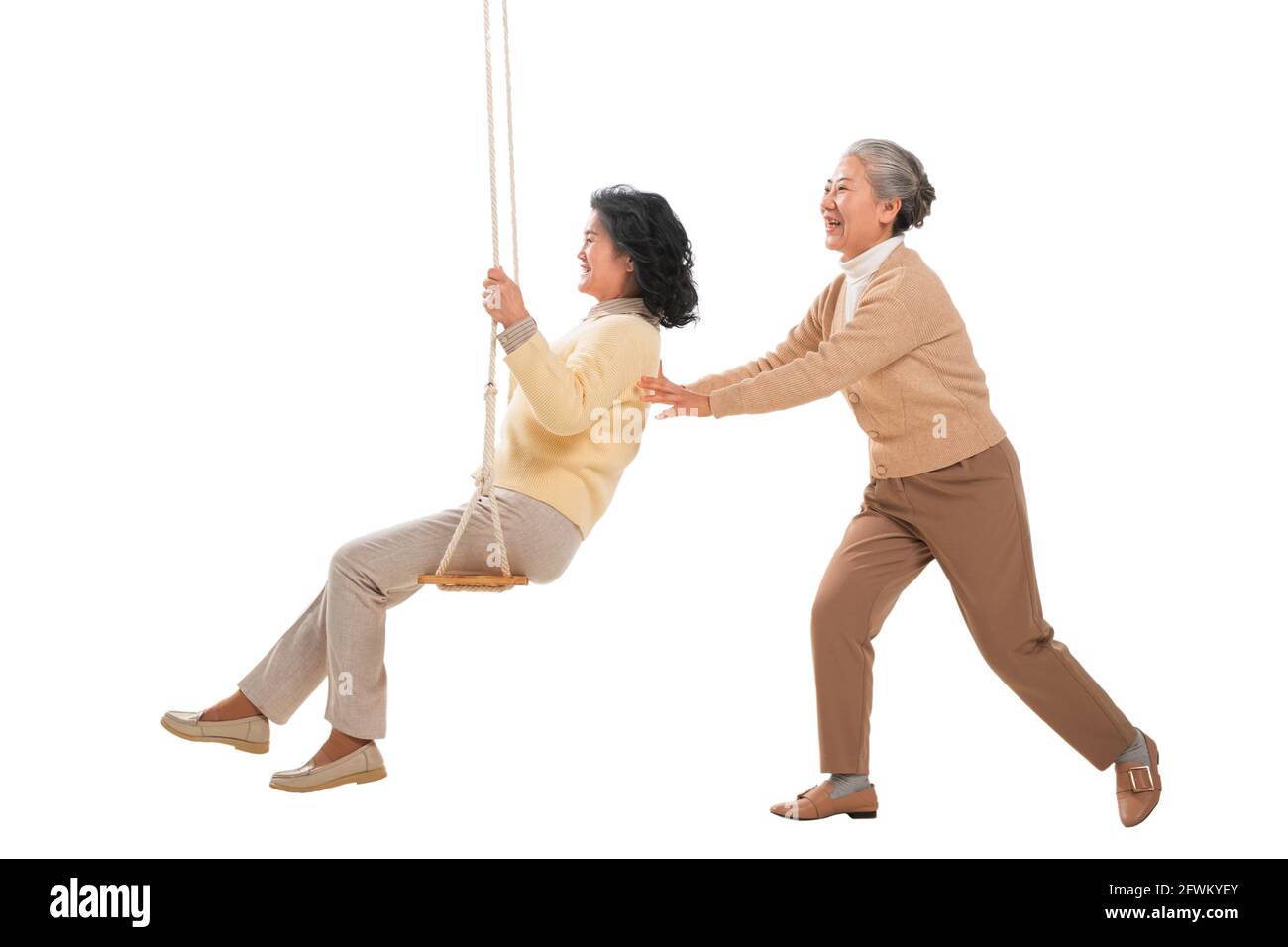 Happy old people on the swings Stock Photo - Alamy