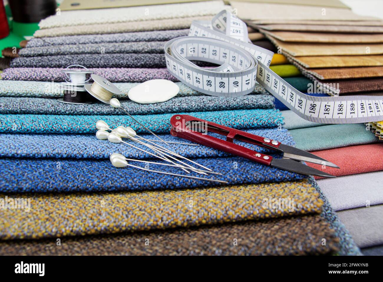 Pieces of cloth with scissors, needle and thread. Tailoring ...