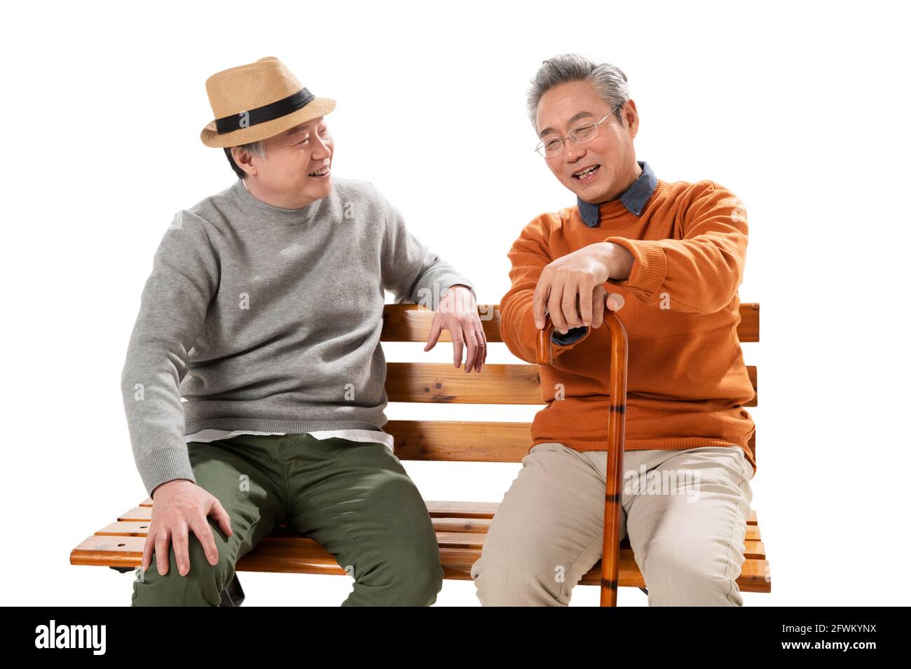The two old friends sat on the bench to chat Stock Photo - Alamy