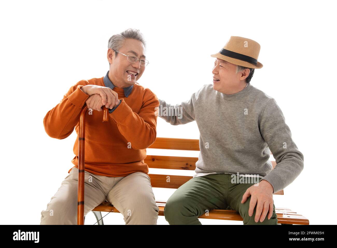 The two old friends sat on the bench to chat Stock Photo - Alamy
