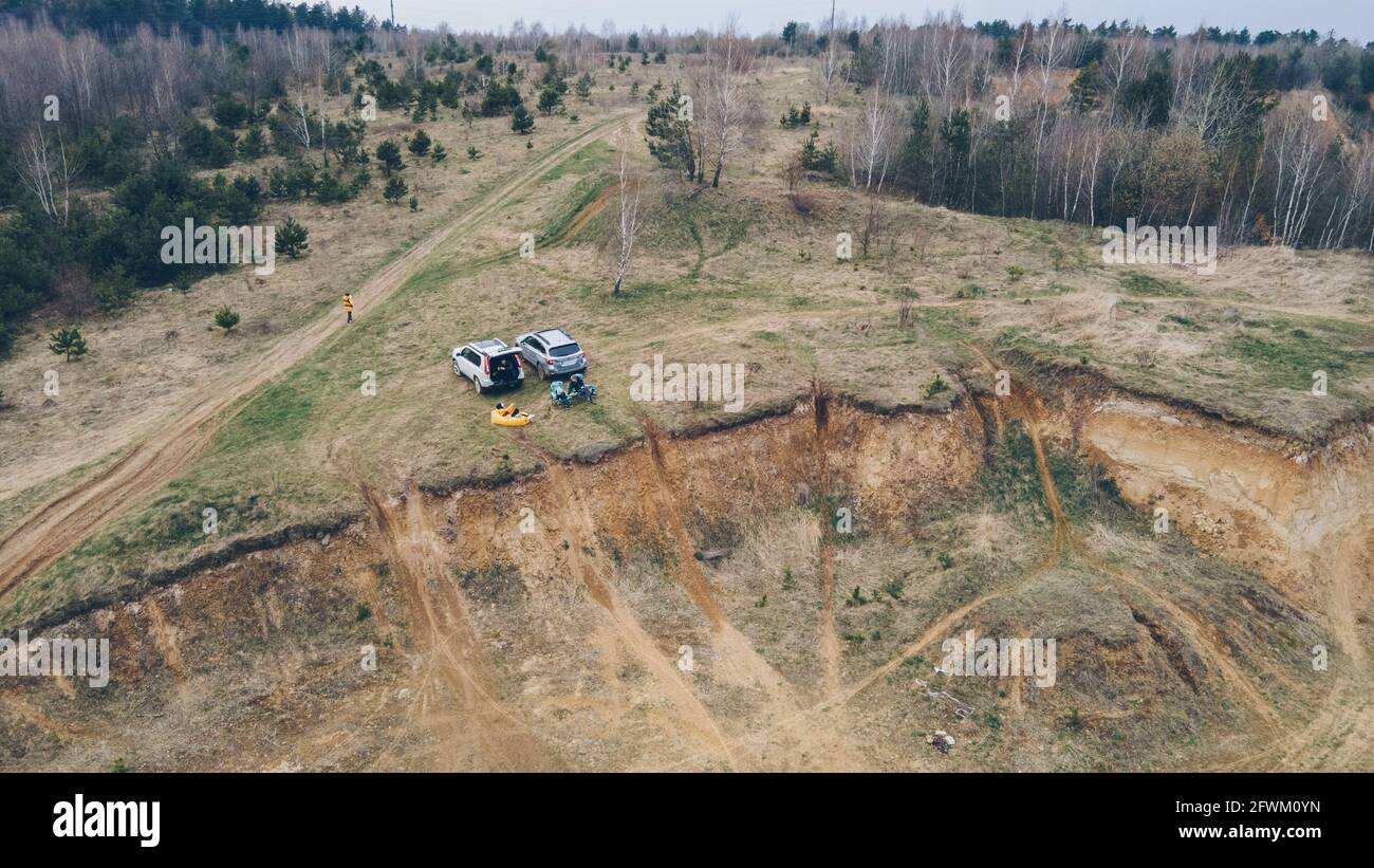 aerial view of campsite two suv car with camping chairs. people resting ...