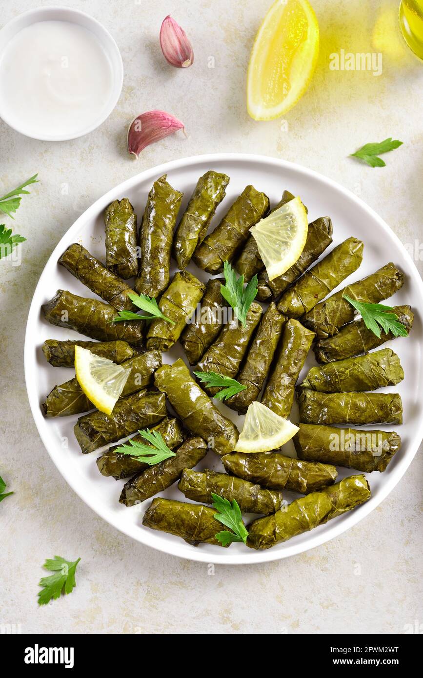 Dolma, stuffed grape leaves with rice and meat on light stone ...