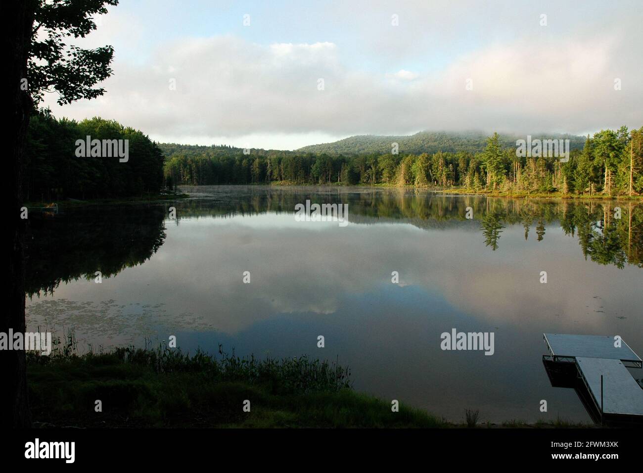 Beautiful lake with reflections in Adirondack mountains Stock Photo - Alamy