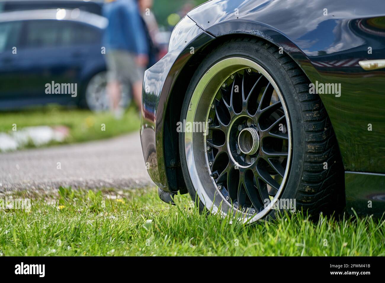 Rear side view front wheel of black car Stock Photo - Alamy