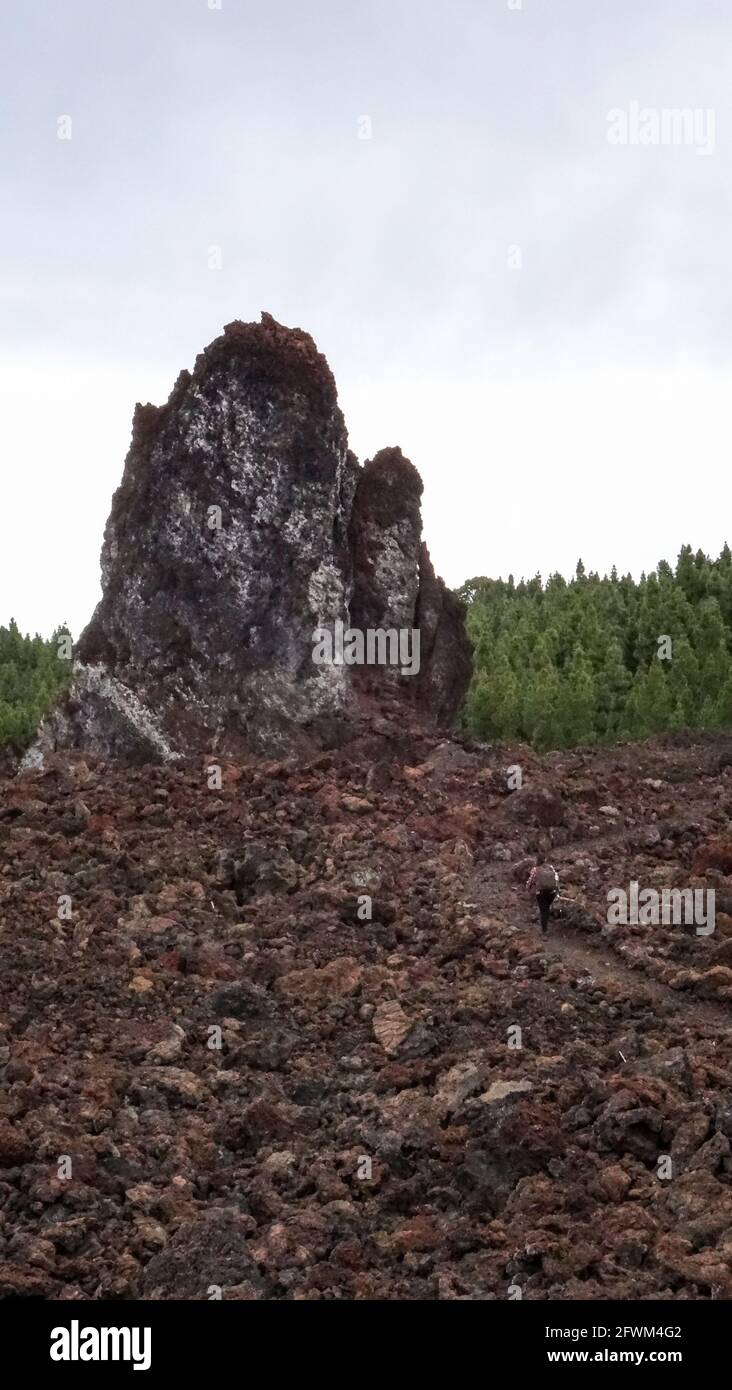 hiking path through lava field with big rock formation, Tenerife, Spain ...