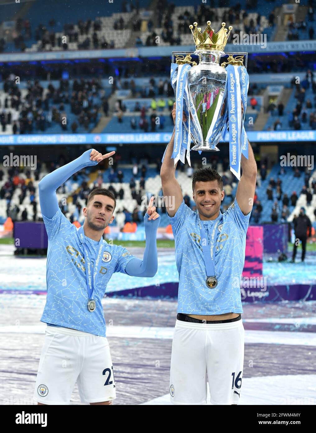 Manchester City's Ferran Torres (left) and Rodri pose with the trophy ...