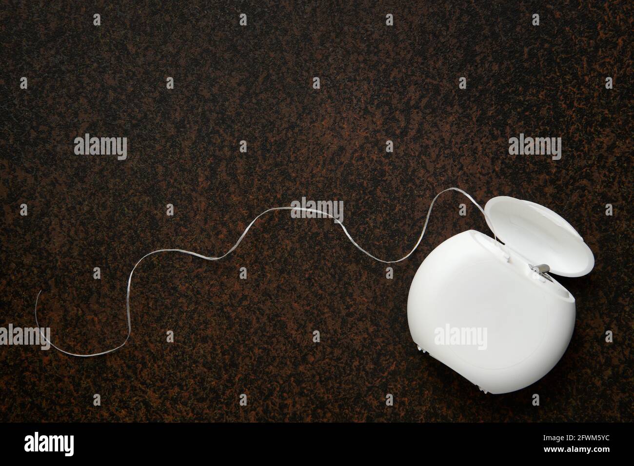 Dental floss on a dark background with copy space Stock Photo - Alamy