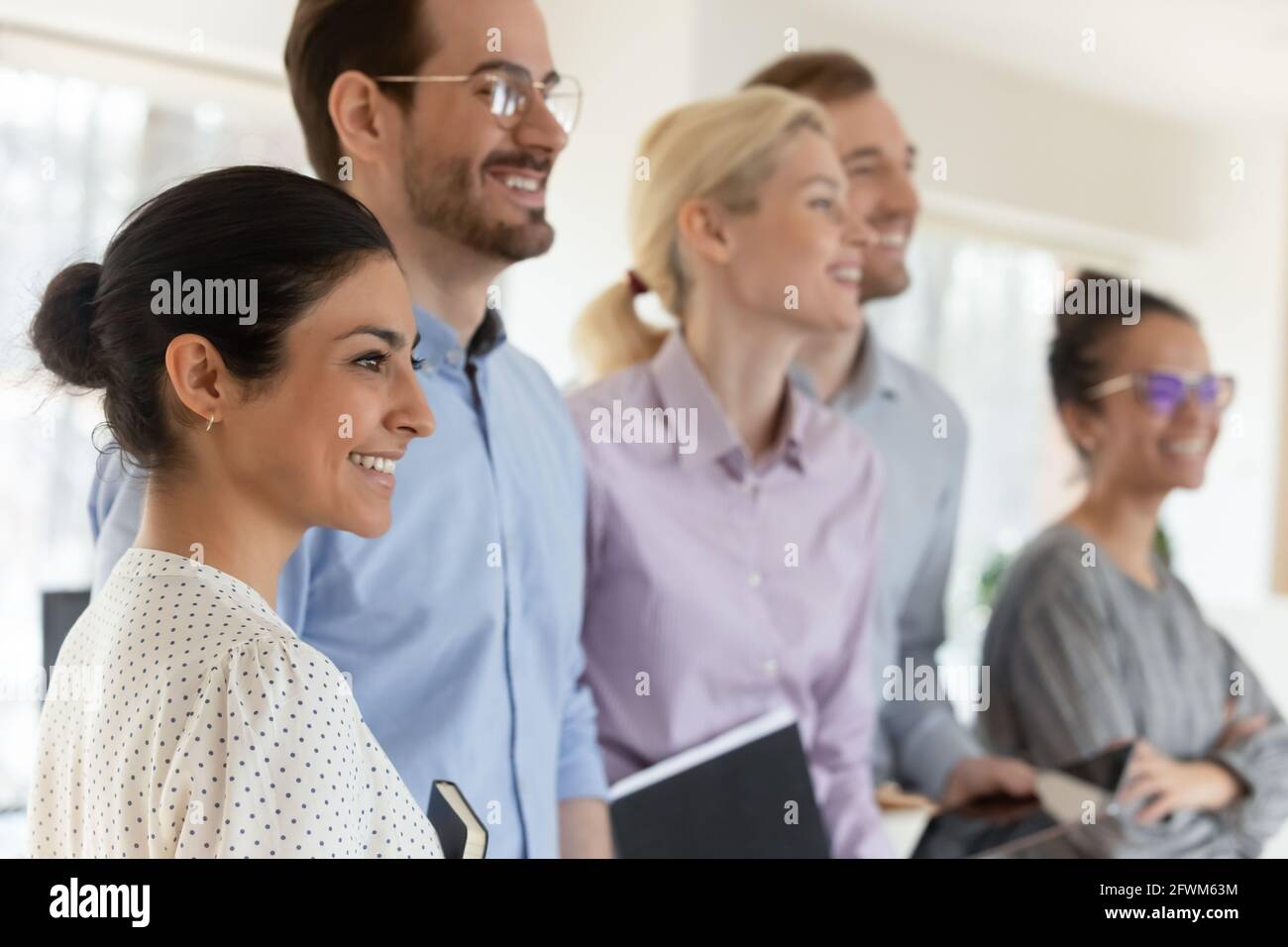 Close up happy diverse motivated employees team standing in office ...