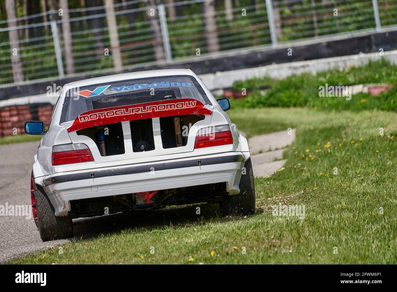 Rear-side view of a car on nature background. Car parked at side of ...