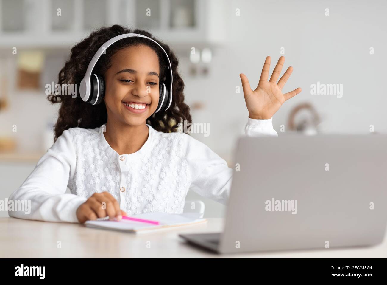 Positive african american kid waving at laptop screen Stock Photo - Alamy