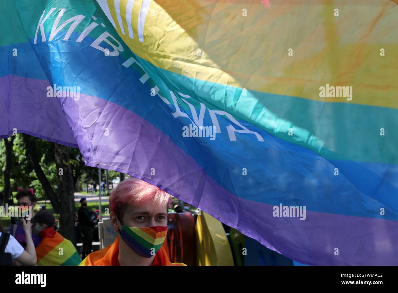KYIV, UKRAINE - MAY 22, 2021 - A demonstrator with the KyivPride flag ...