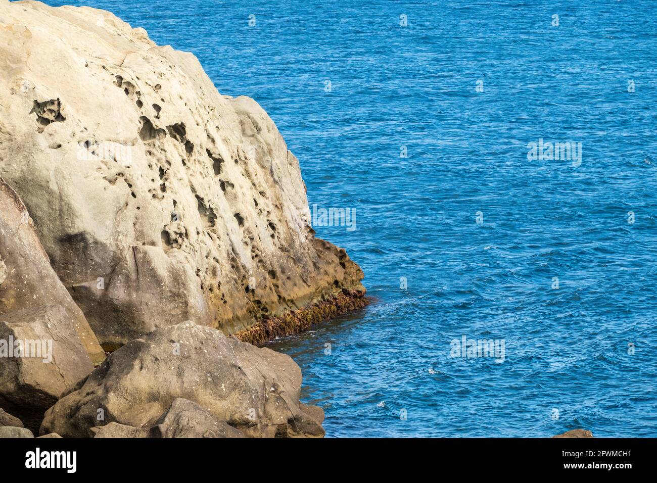 Sea and rocks at cloudy day. Stone cliff on the sea shore Stock Photo ...