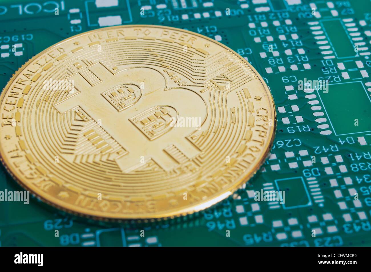 Bitcoins on green circuit board background close up Stock Photo - Alamy