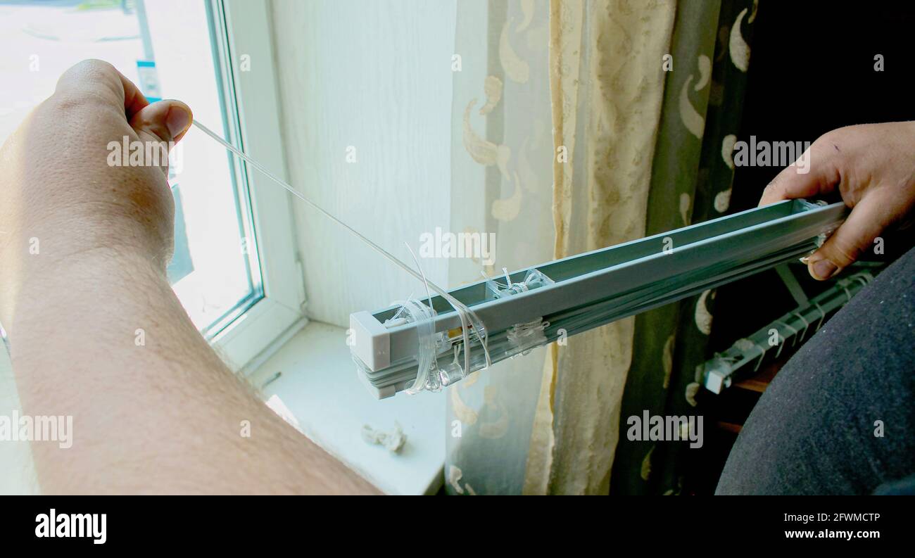 Window blinds installation process. Male hands close up Stock Photo - Alamy