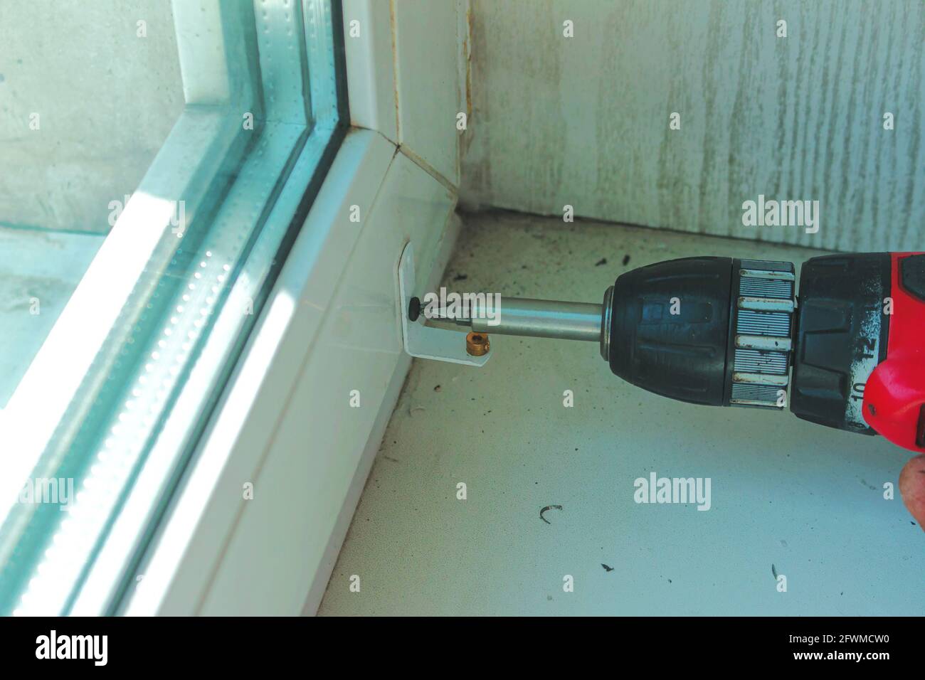 Window blinds installation process. Working with a drill Stock Photo ...