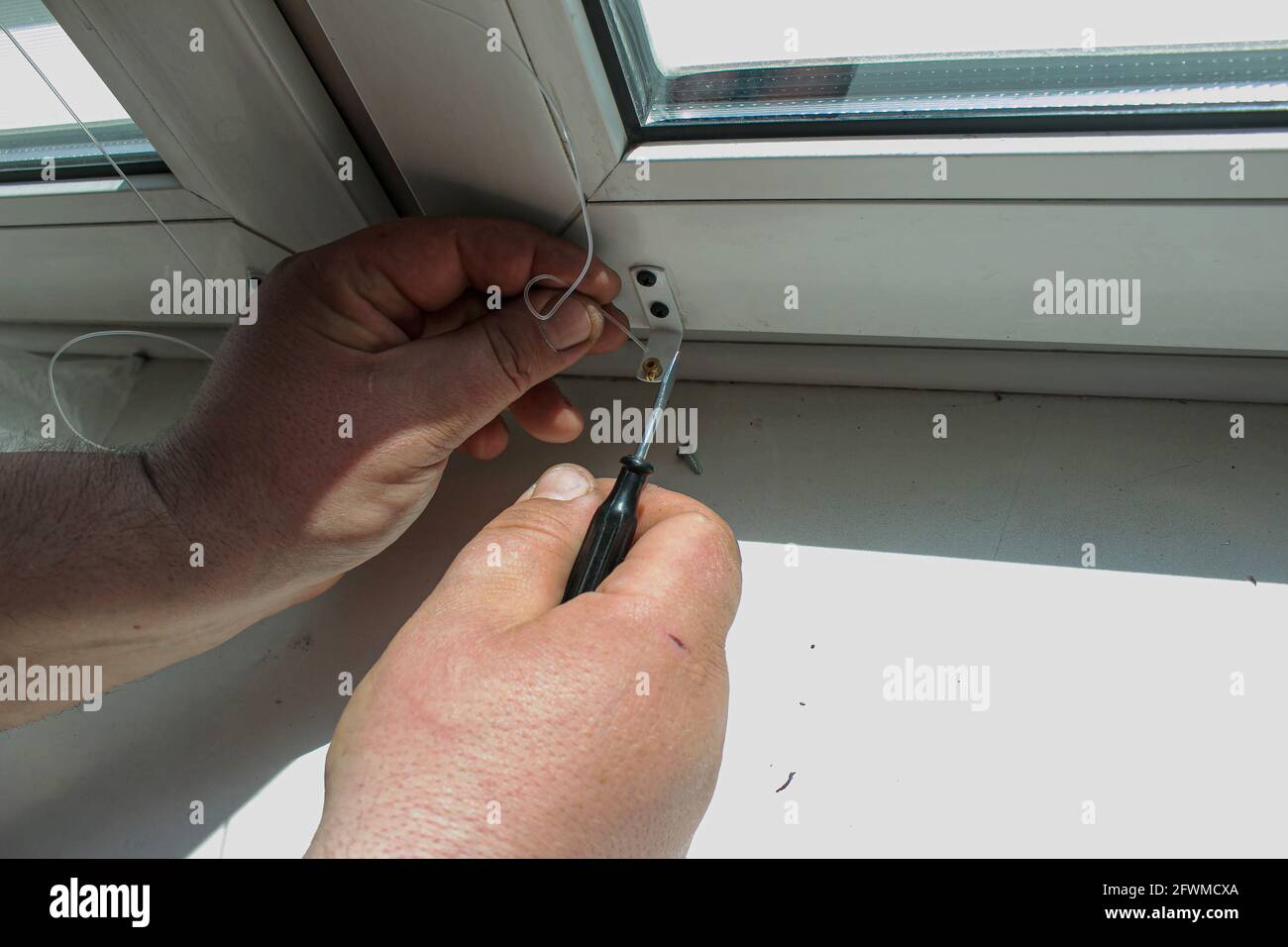 Window blinds installation process. Male hands close up Stock Photo - Alamy