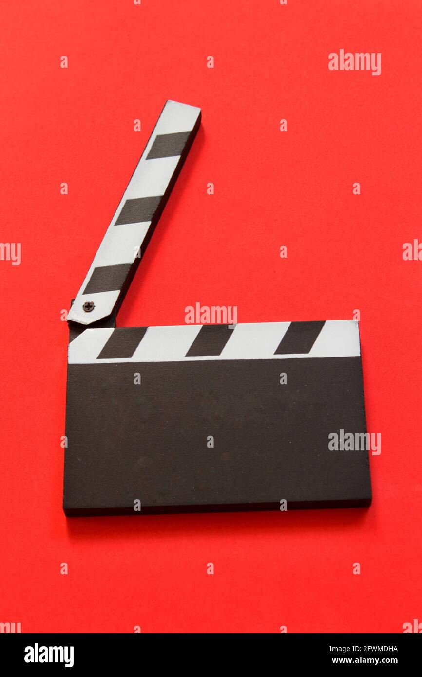 Movie clapper isolated on red background. Top view. Entertainment ...