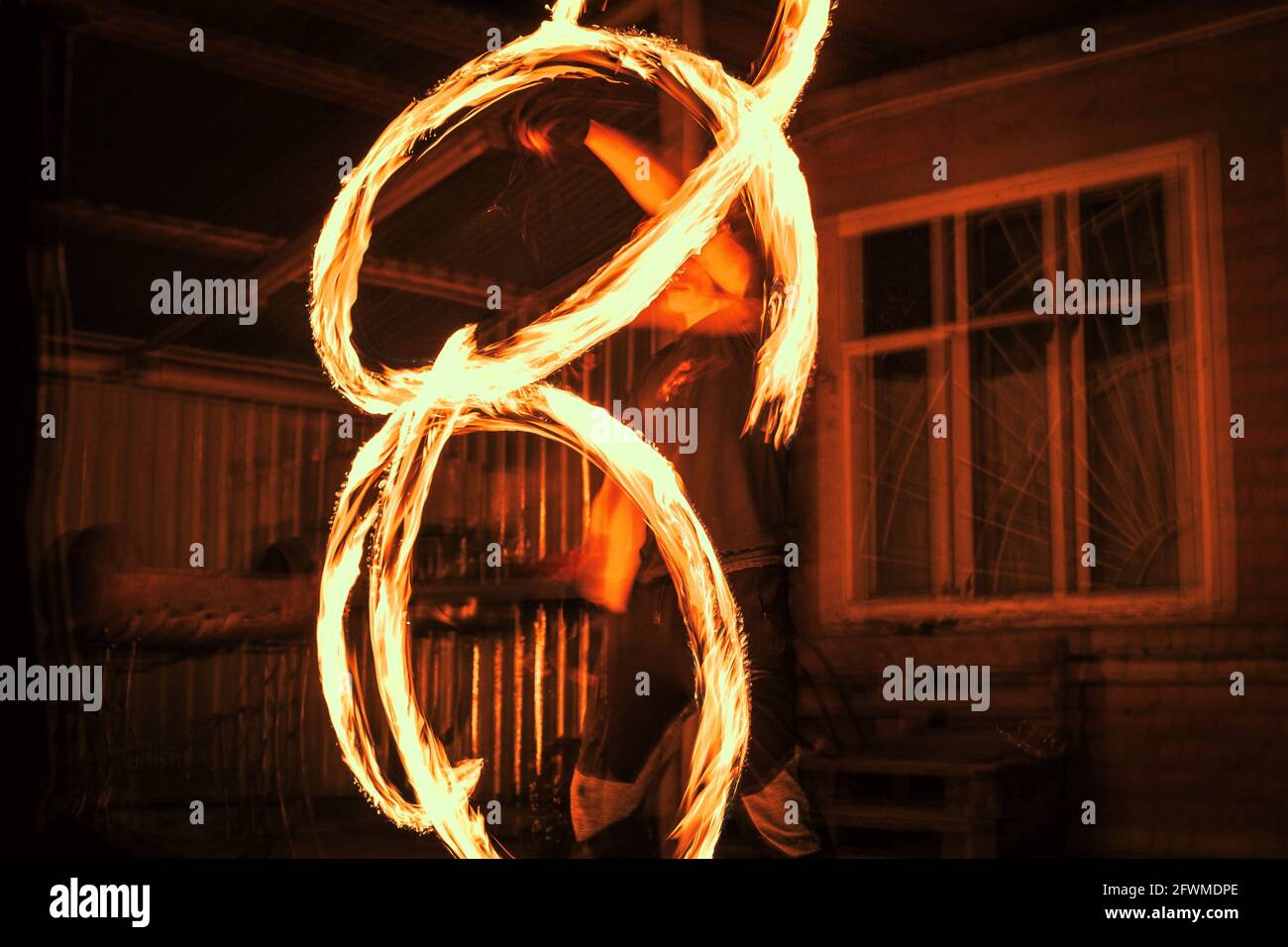 The spinning fire dancer performing burning fire poi dance Stock Photo ...