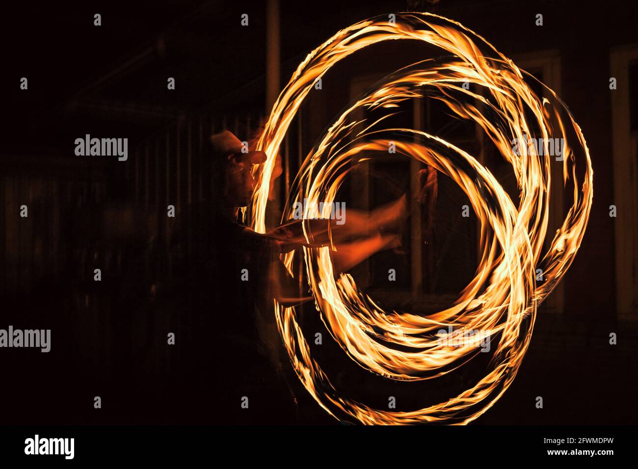 The spinning fire dancer performing burning fire poi dance Stock Photo ...