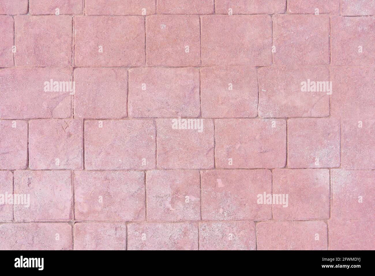 Front view of a wall of irregular shape tiles or slabs. Reddish ...