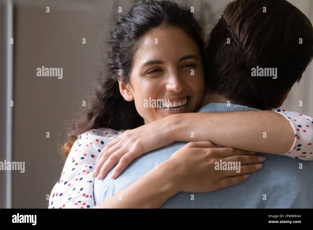 Emotional sincere young woman cuddling beloved husband Stock Photo - Alamy