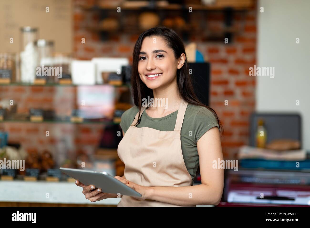 Woman at counter waiting for customers hi-res stock photography and ...