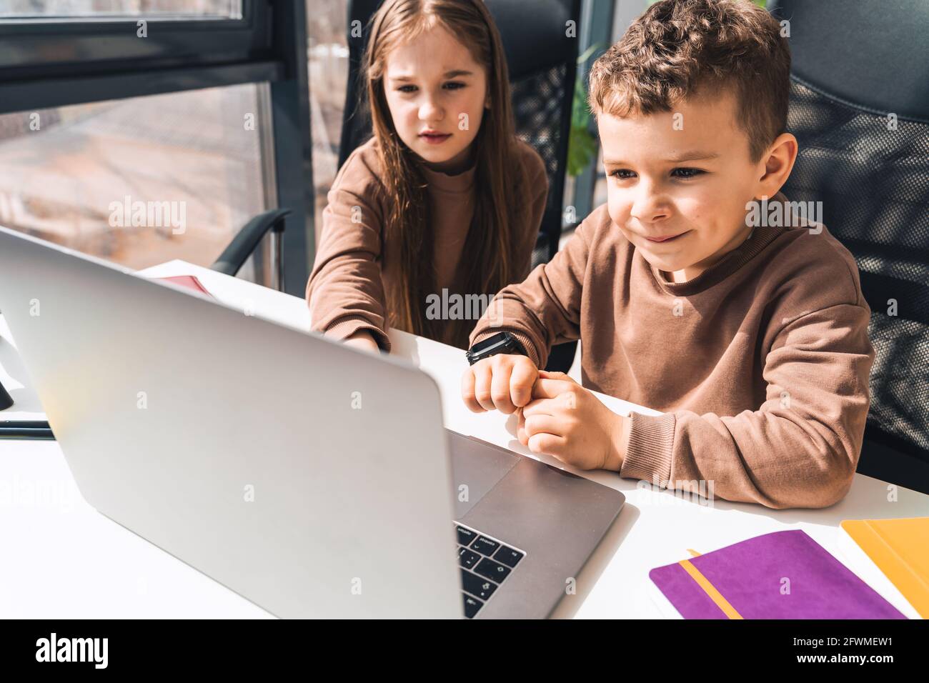 Little boy and girl study online in home at the laptop Stock Photo - Alamy