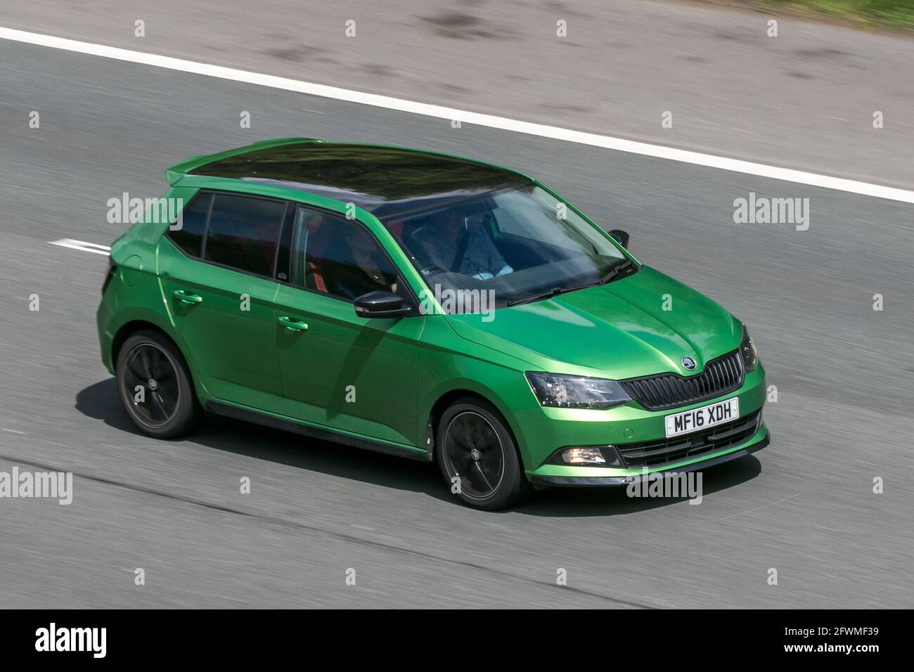 2016 green Skoda Fabia Monte Carlo TSi driving on the M6 motorway near ...