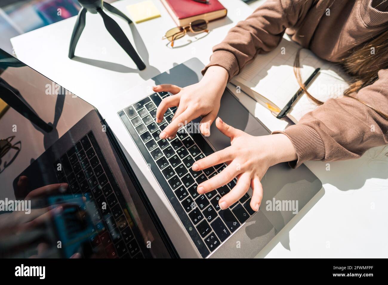 Little girl's hands are typing on laptop Stock Photo - Alamy