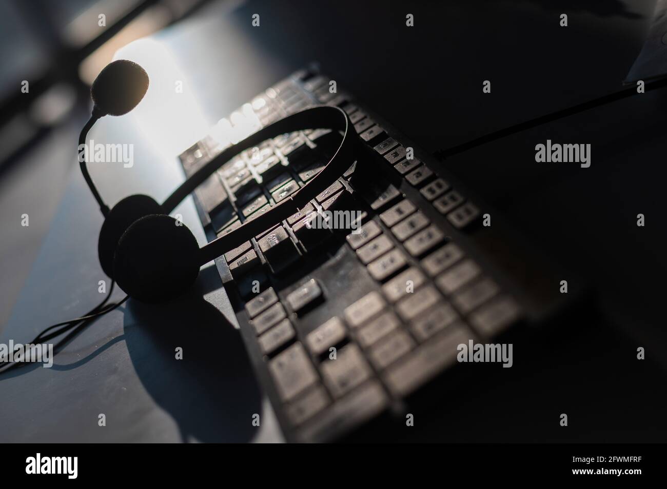 Headset with microphone on the computer keyboard. Call center operator ...
