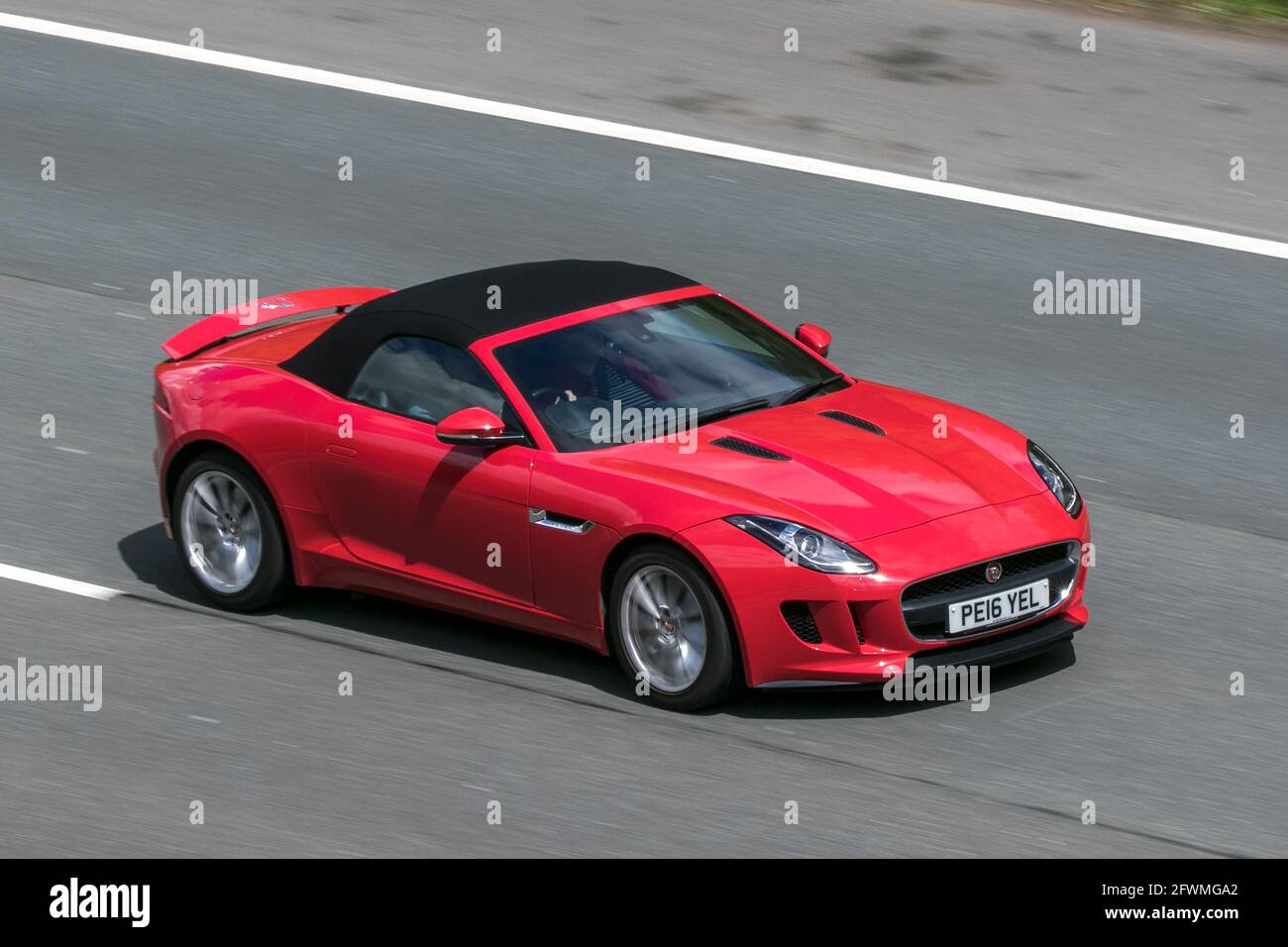 JAGUAR red F-TYPE PETROL driving on the M6 motorway near Preston in ...