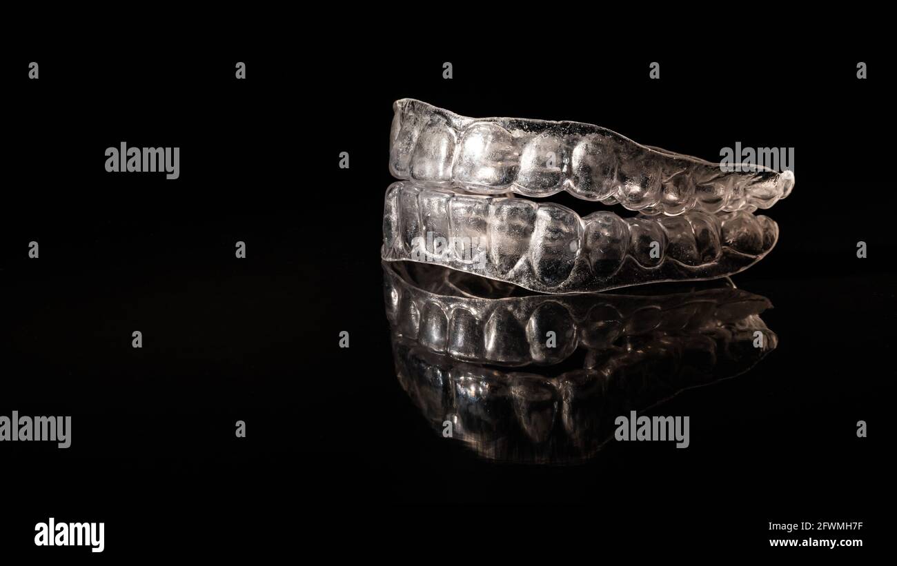 Removable plastic retainers on black background Stock Photo - Alamy