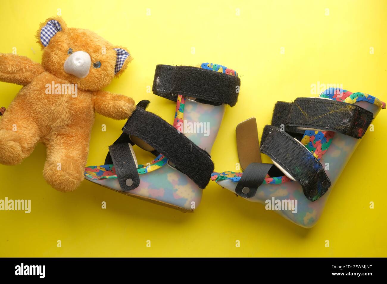 Child cerebral palsy disability shoes on yellow background Stock Photo ...