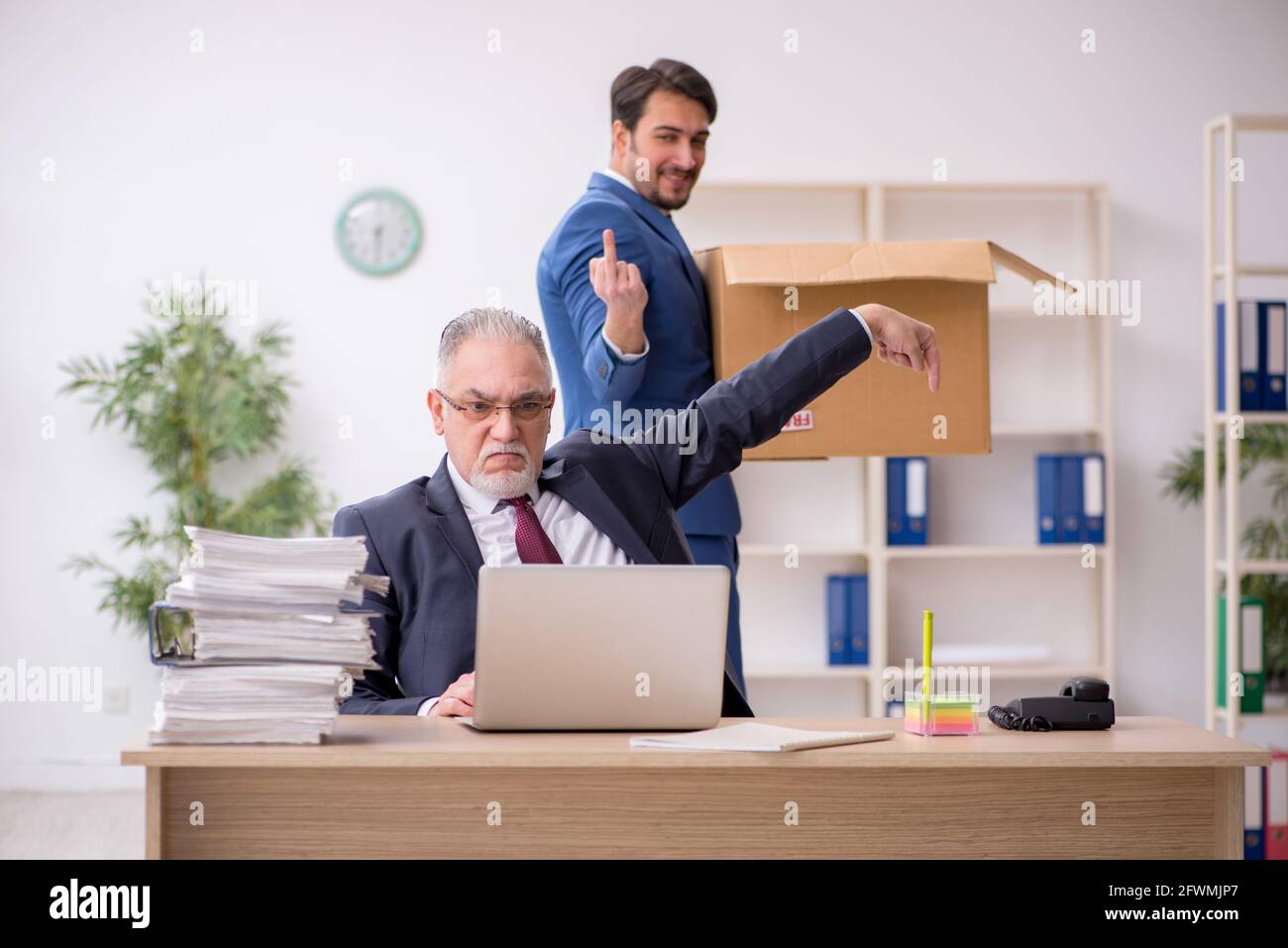 Two employees in dismissal concept Stock Photo - Alamy