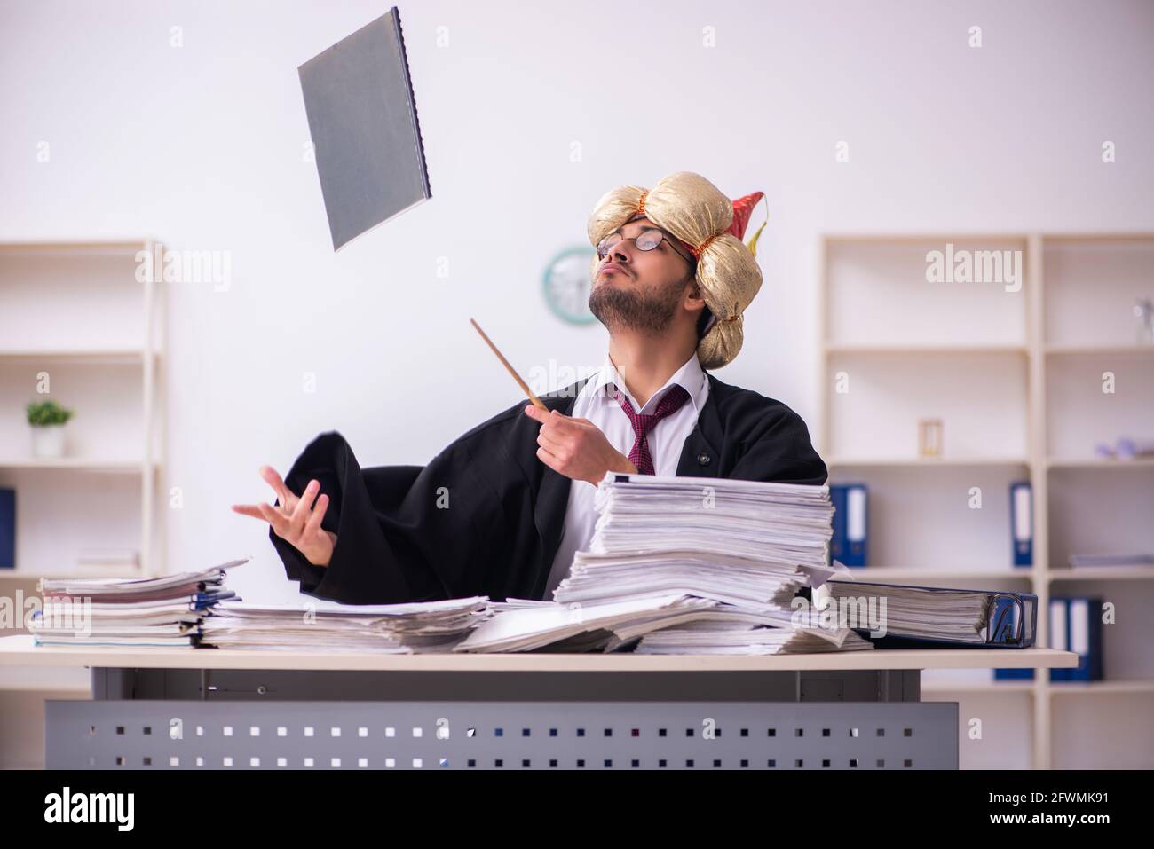 Funny young employee magician and too much work in the office Stock ...