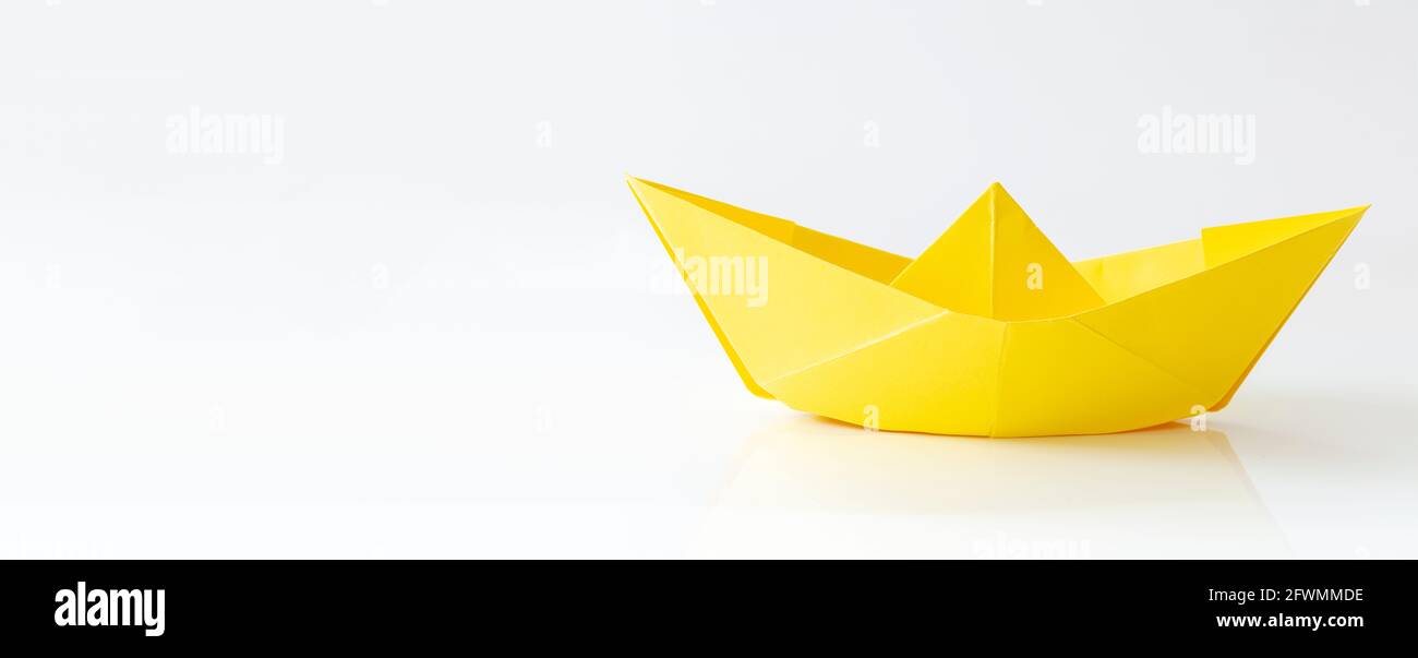 Yellow Paper boat isolated on white background with copy space, banner ...