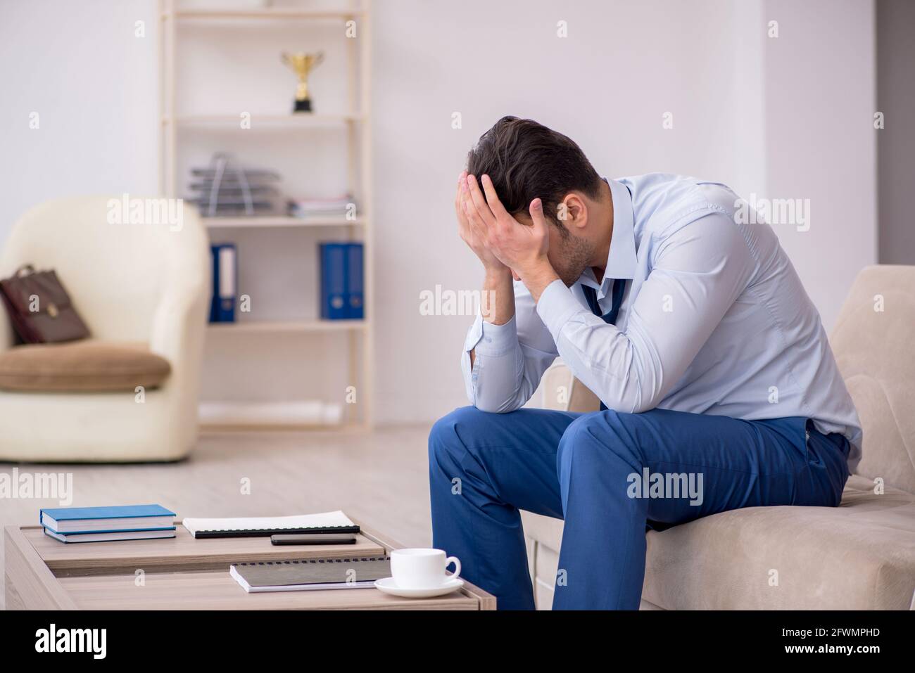 Young male employee waiting for business meeting Stock Photo - Alamy