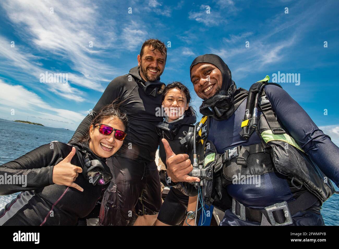 four friends after successful dive in Raja Ampat / Indonesia Stock ...