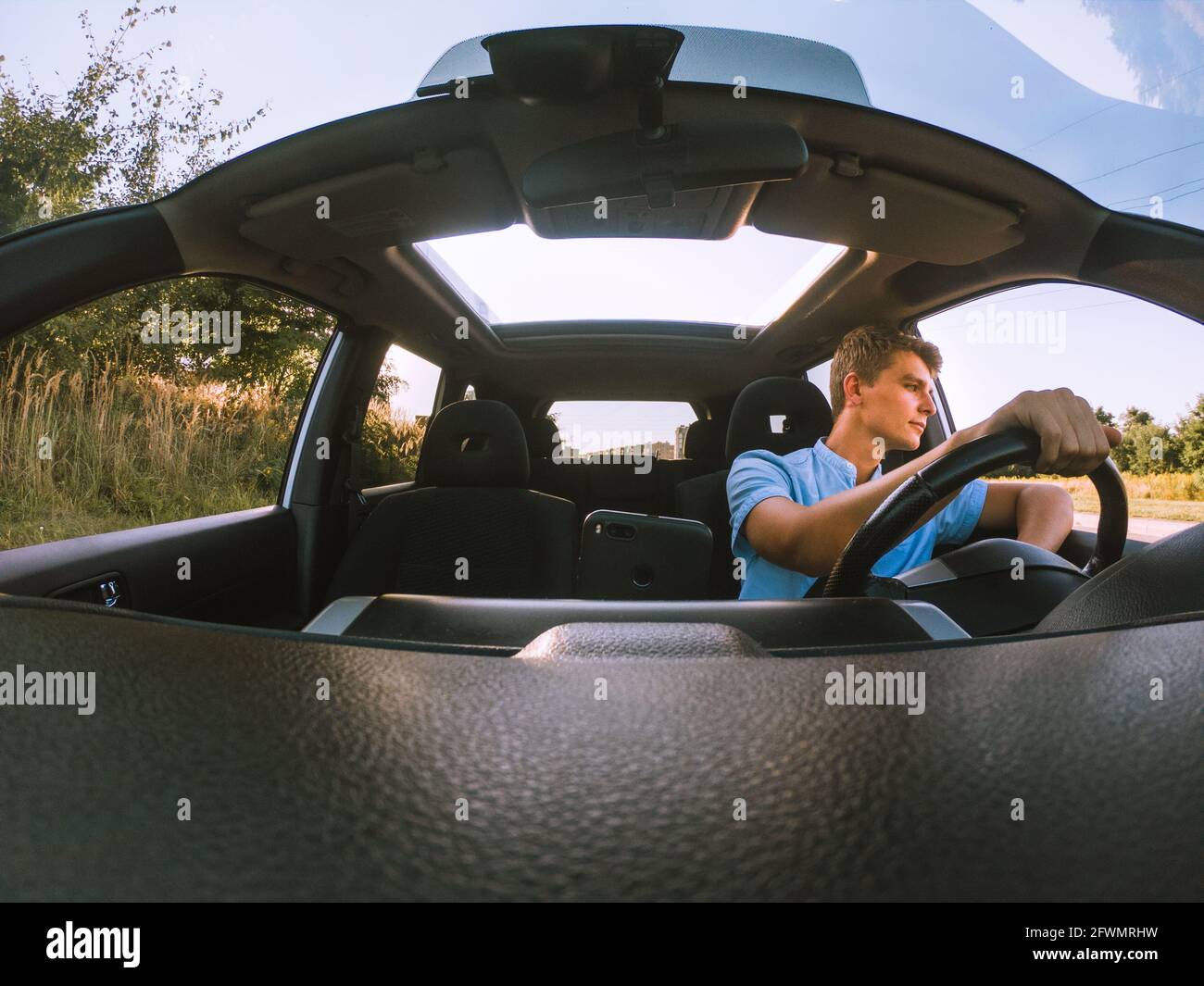 man sitting inside the car driving copy space Stock Photo - Alamy
