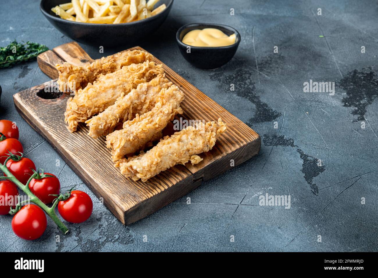 Crispy fried chicken broast cuts on grey background, with copy space ...