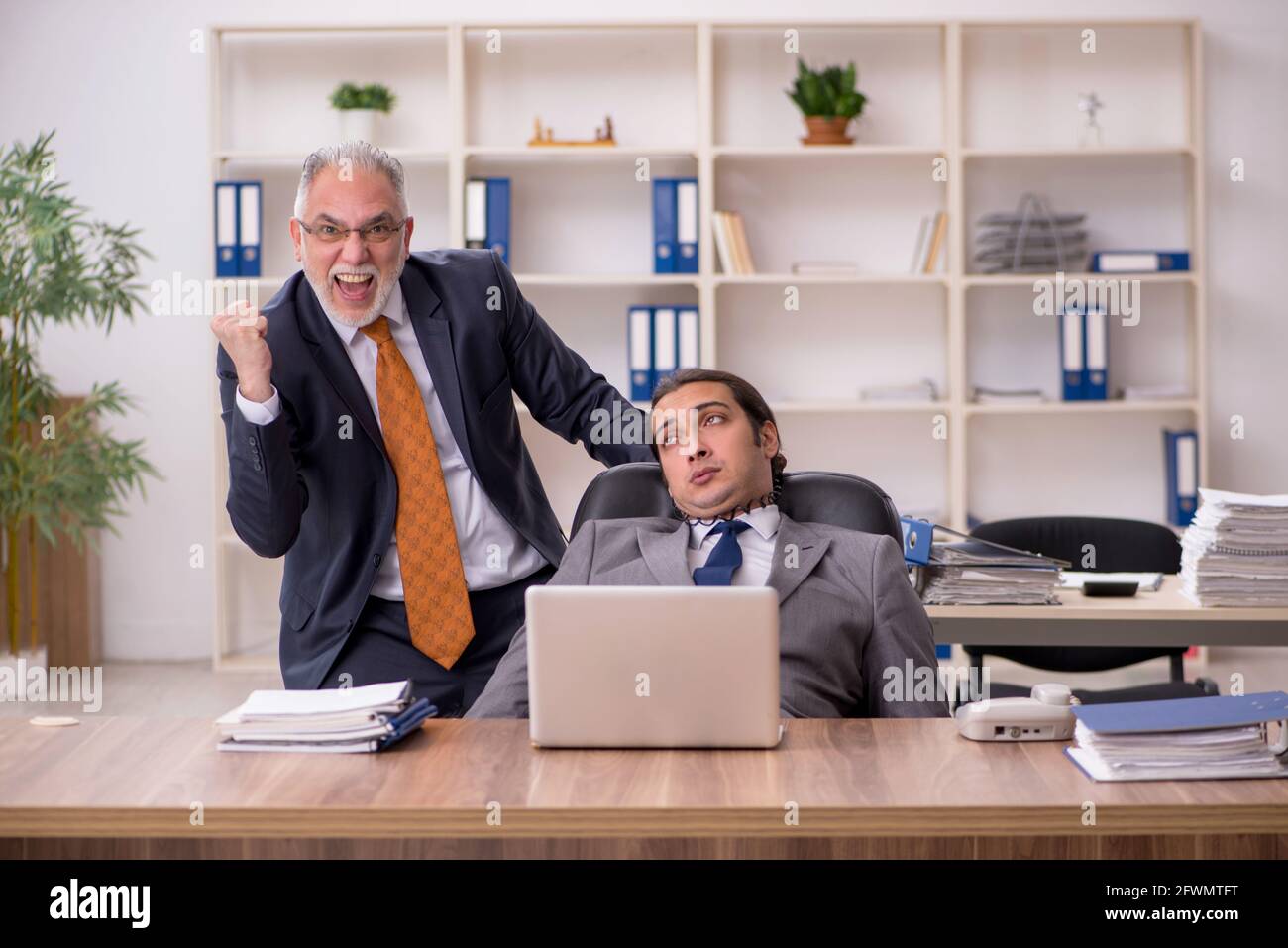 Two male employees in bullying concept Stock Photo - Alamy