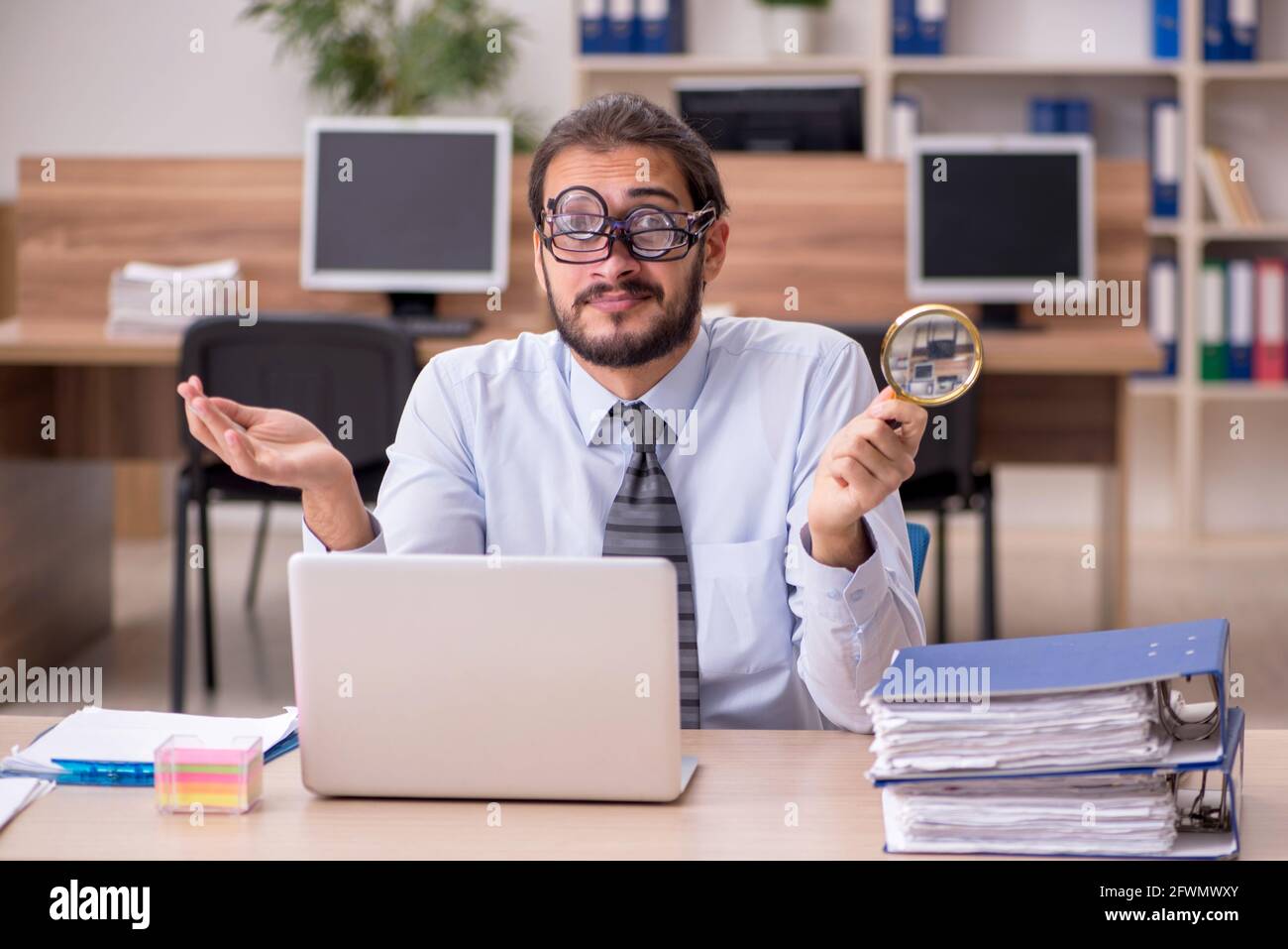 Office work funny young magnifying hi-res stock photography and images - Alamy
